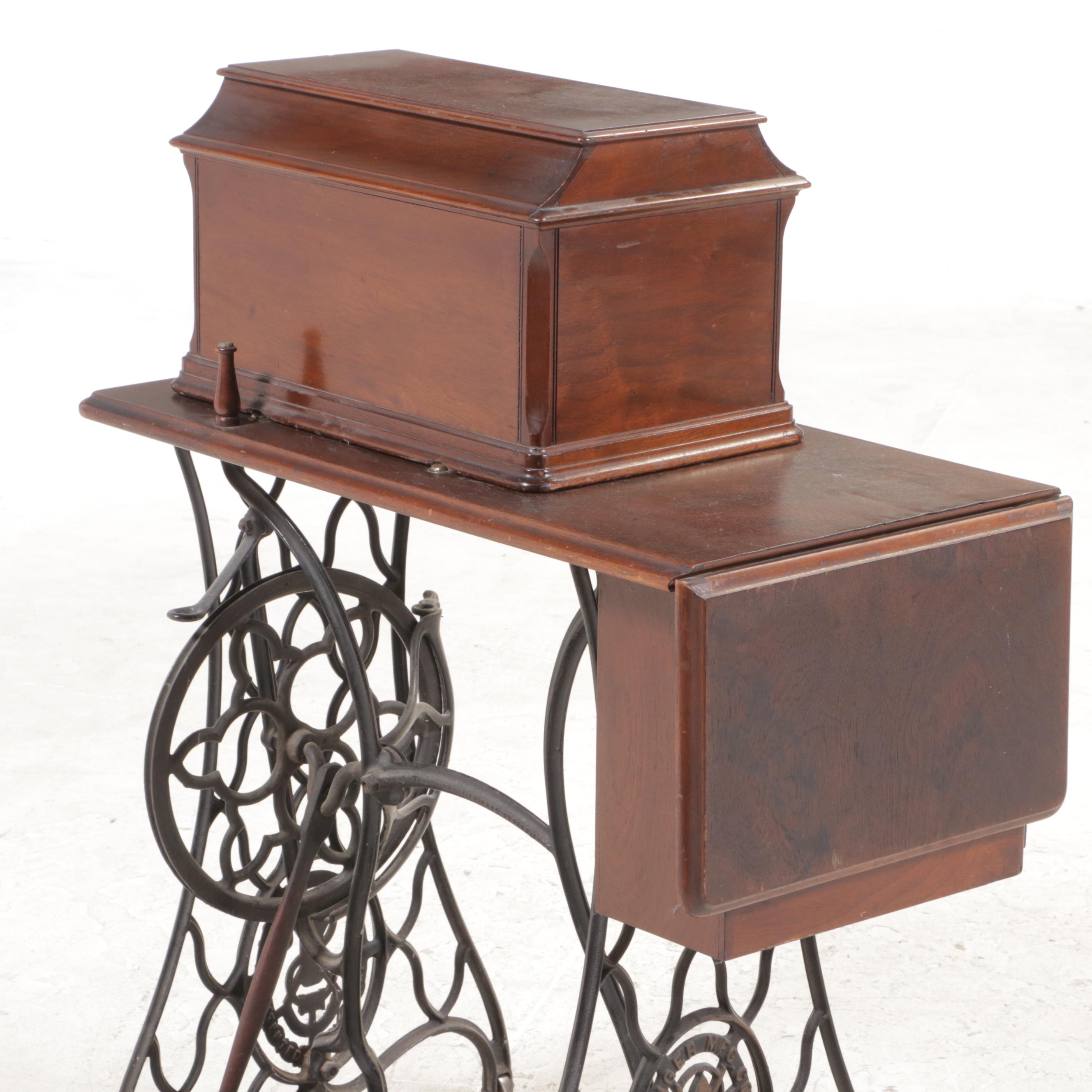 The Singer Mfg. Co. Walnut and Cast Iron Treadle-Base Sewing Machine | EBTH